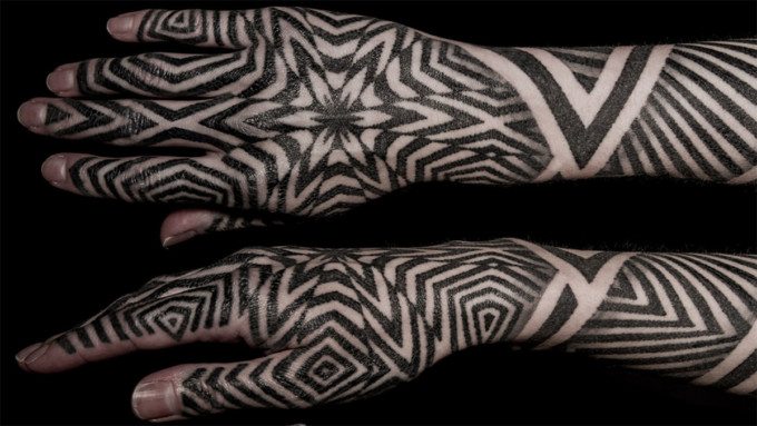 Lewisink's tattoos are clean, rhythmic repetition that borders on absurdity